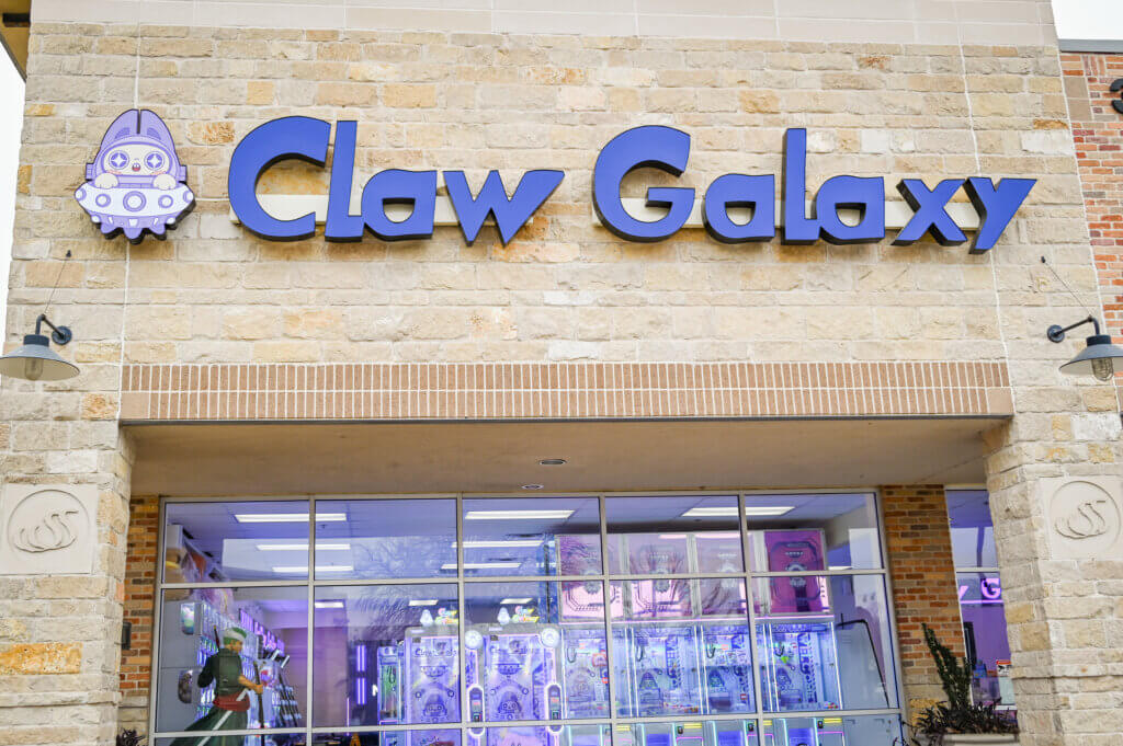Get drawn in by the soft glow of Claw Galaxy arcade - Shop The Rock